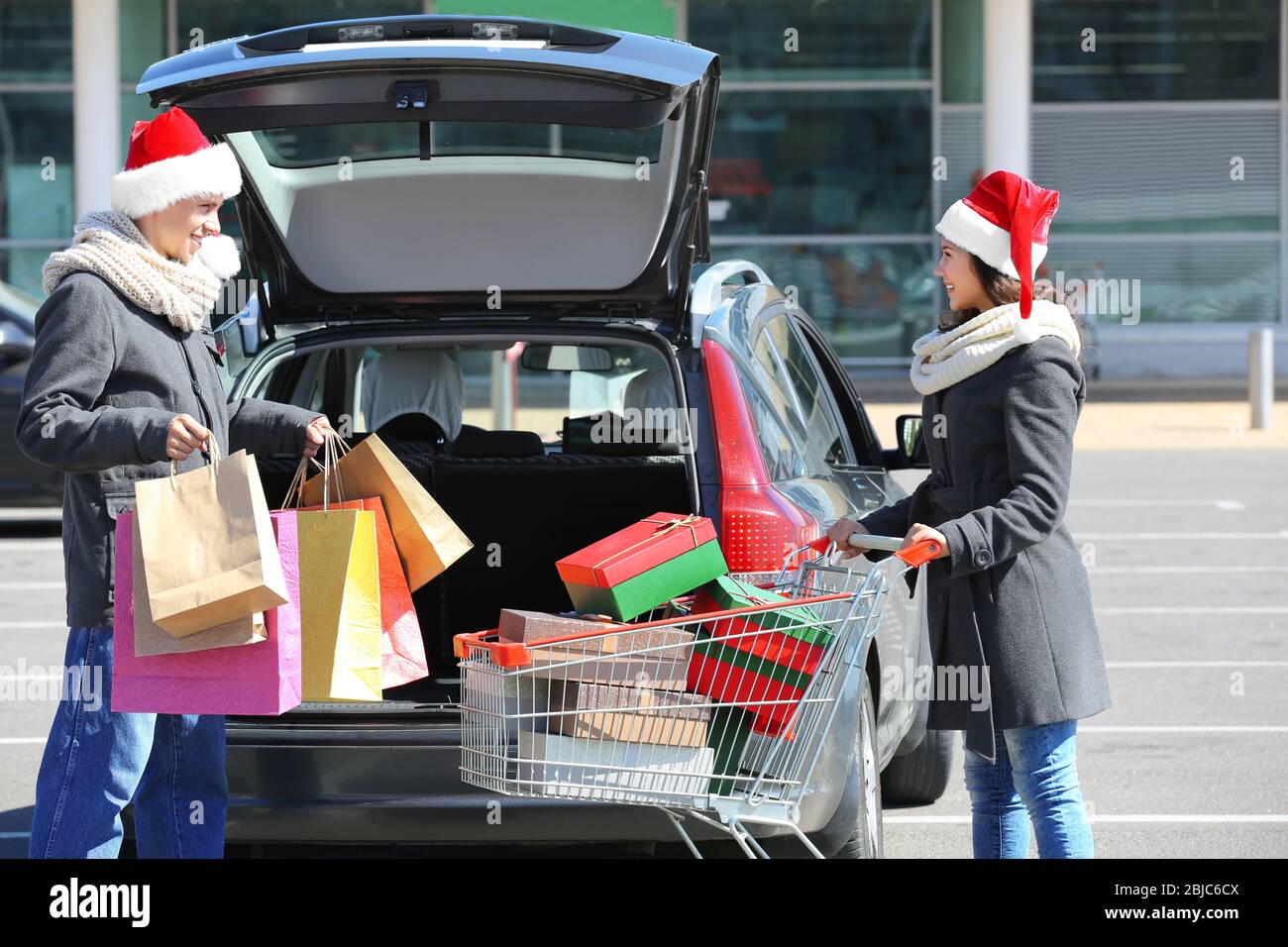 Female shopper loading car hi-res stock photography and images - Alamy