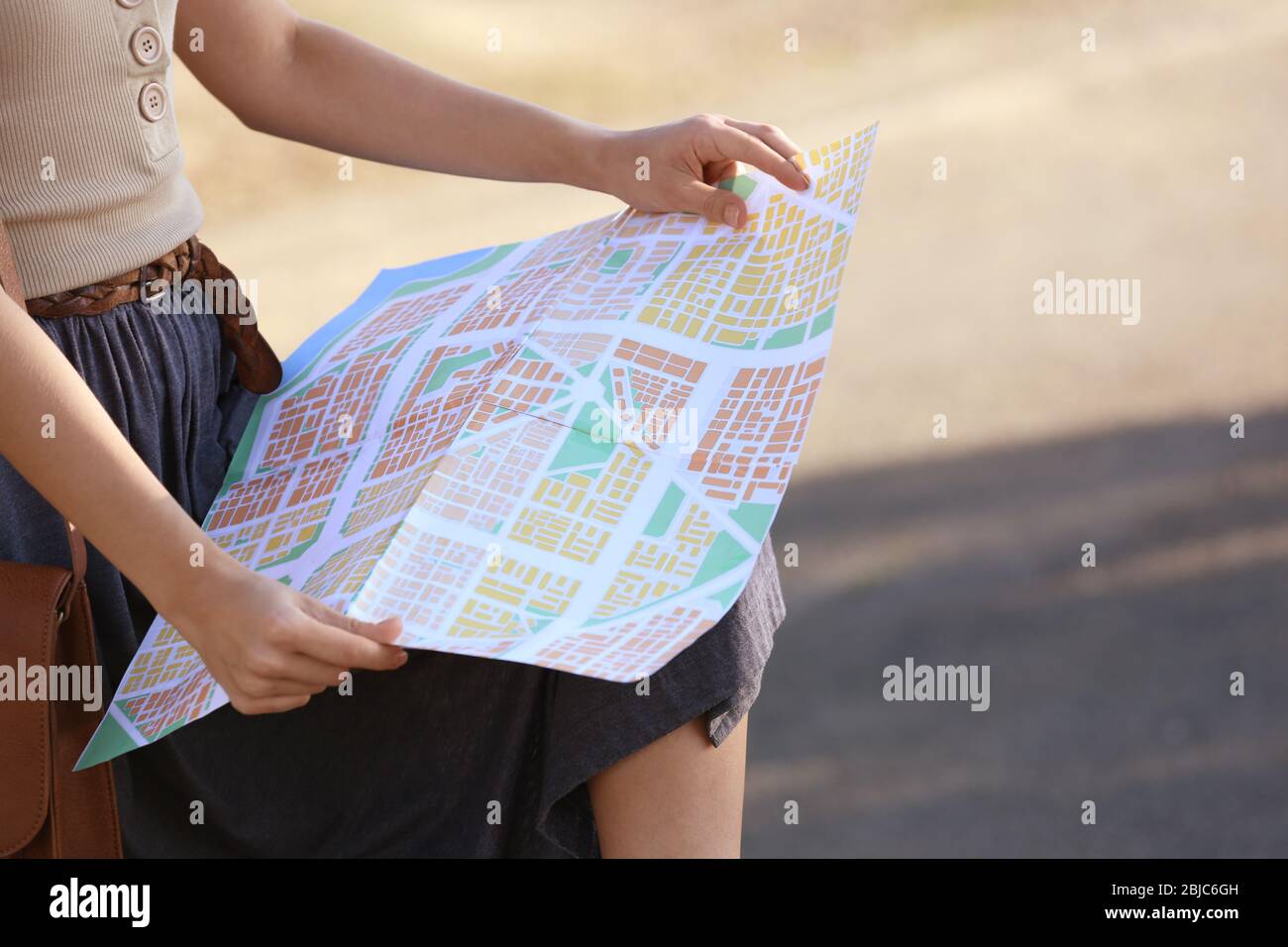 Young woman searching direction on map Stock Photo - Alamy