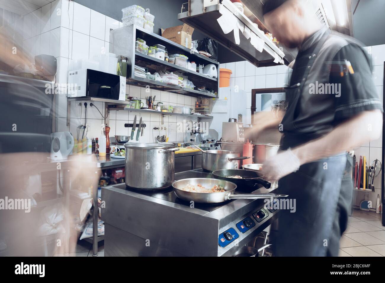 Behind the scenes of brands. The chef cooking in a professional kitchen ...