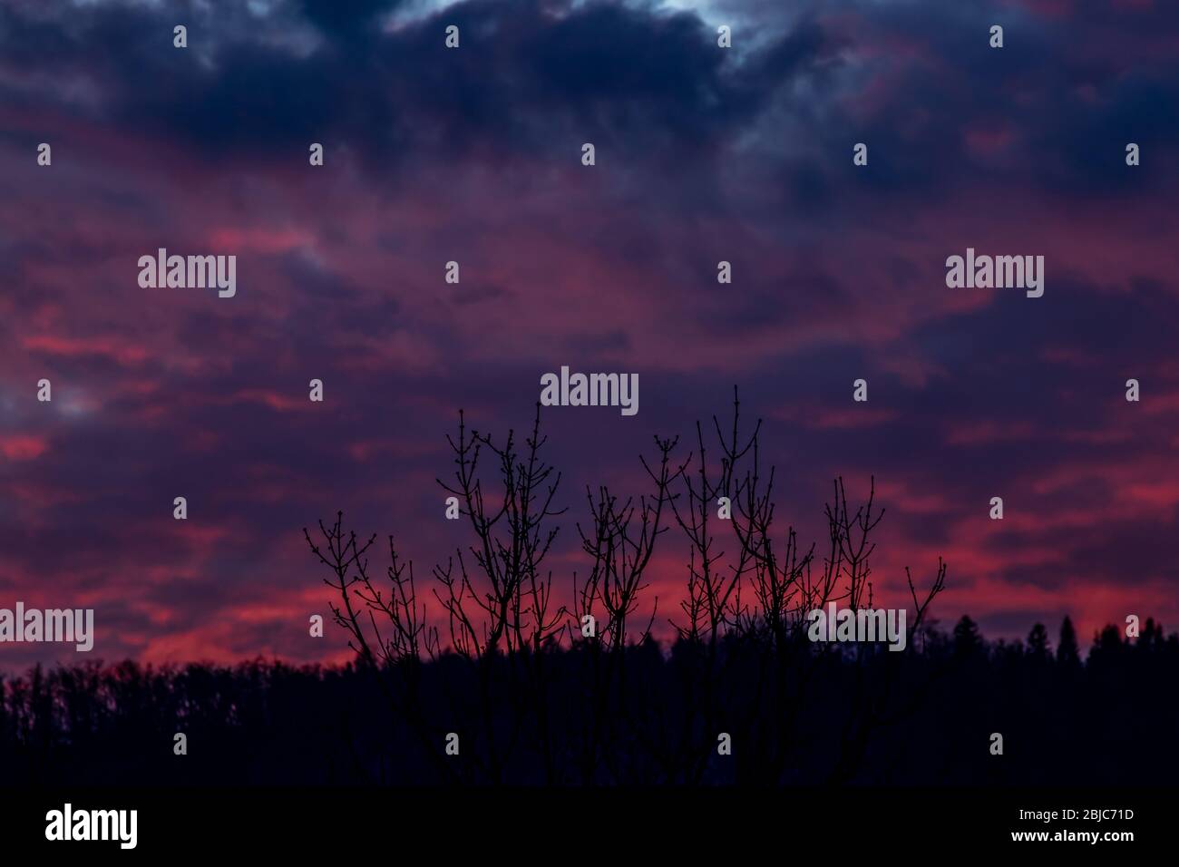 Dark red clouds over landscape Stock Photo - Alamy