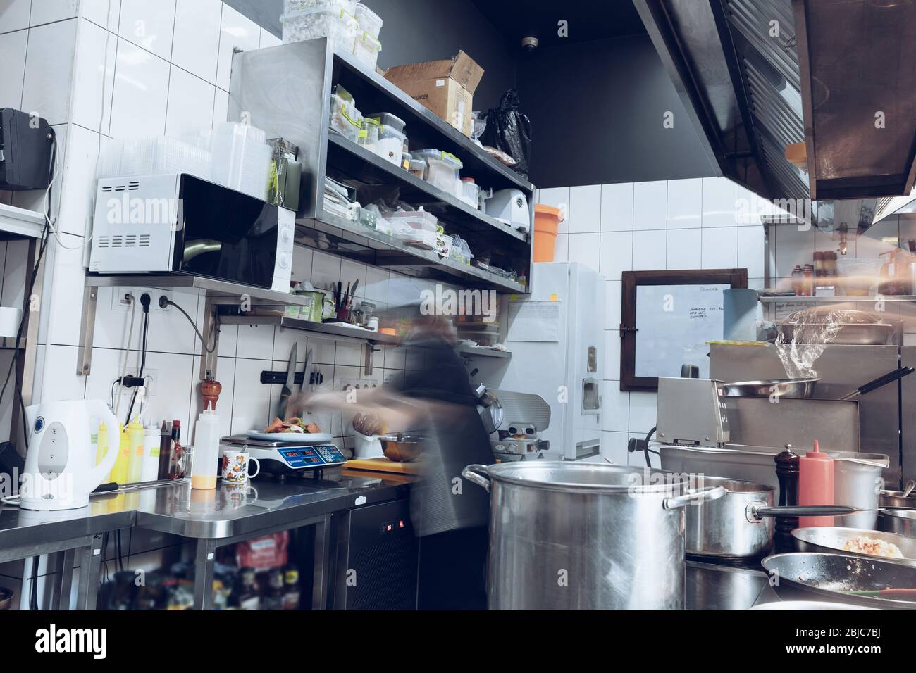 Behind the scenes of brands. The chef cooking in a professional kitchen ...