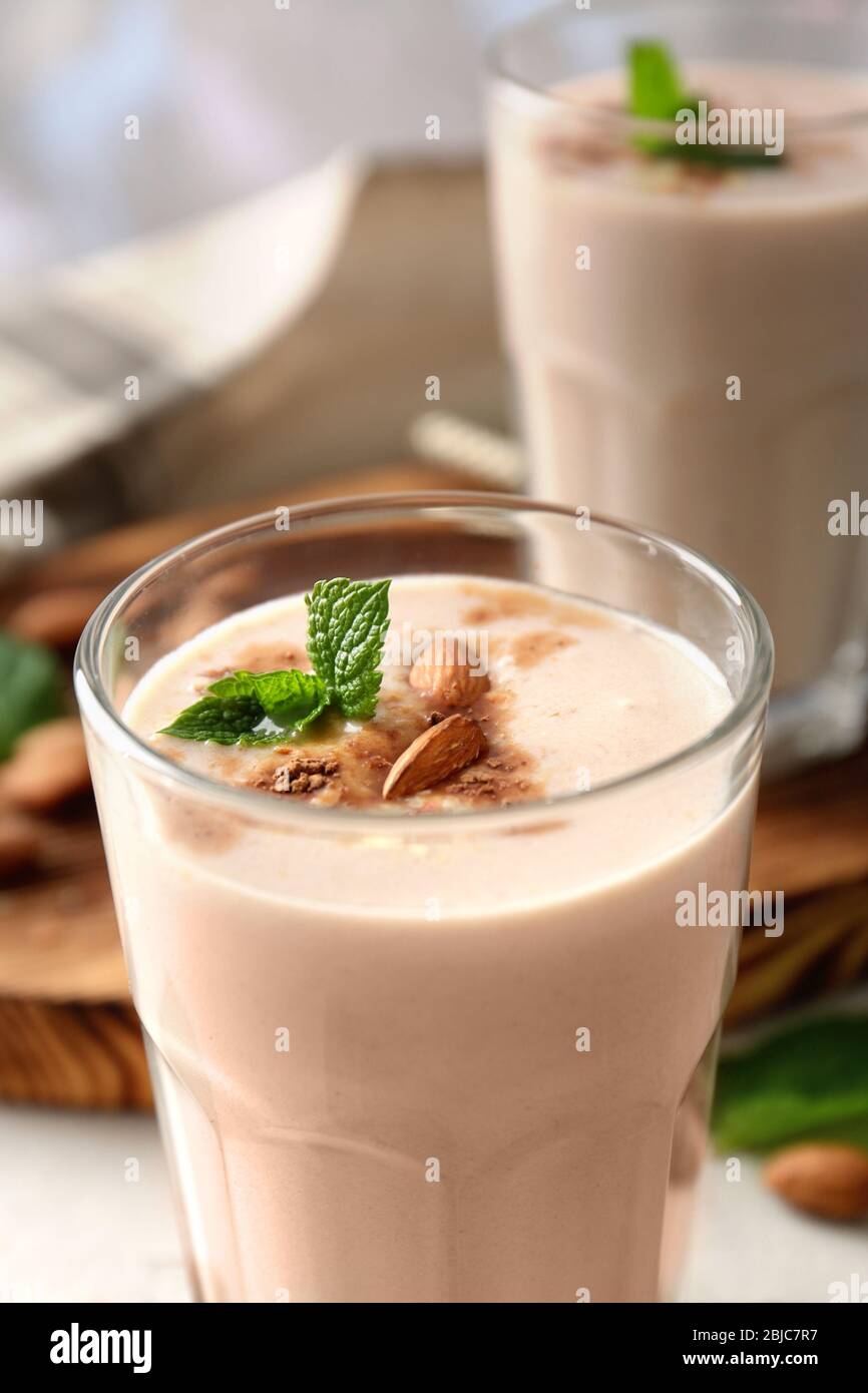 Glass with delicious nut milk shake on table, closeup Stock Photo - Alamy