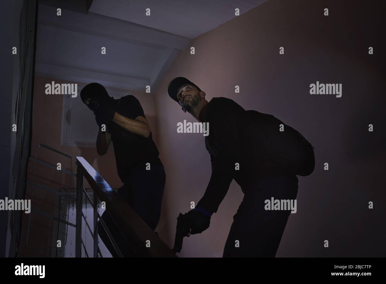 Male thieves on stairs Stock Photo - Alamy