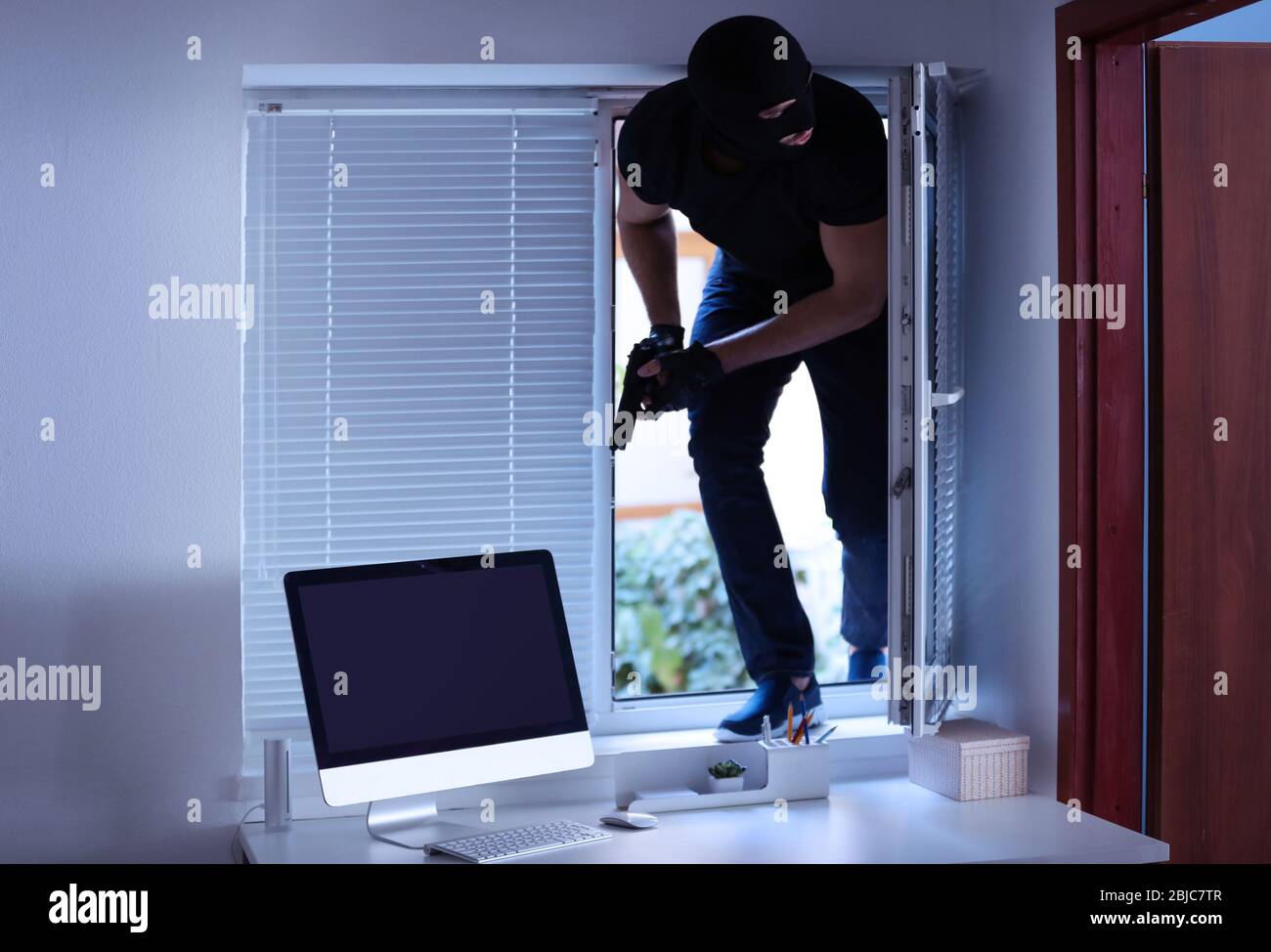 Burglar entering through window hi-res stock photography and images - Alamy