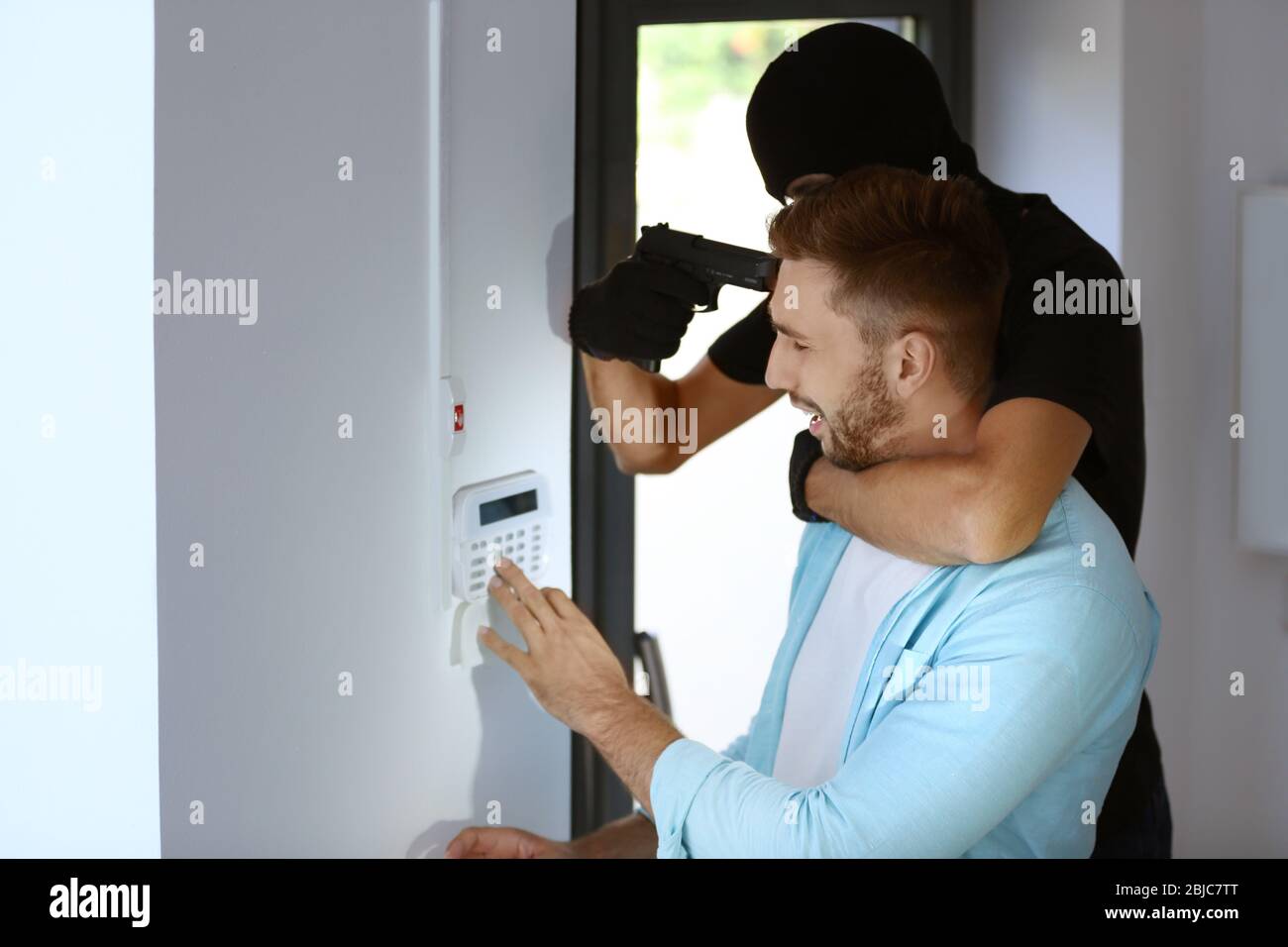 Hostage terrorist burglar threatening gun hi-res stock photography and ...