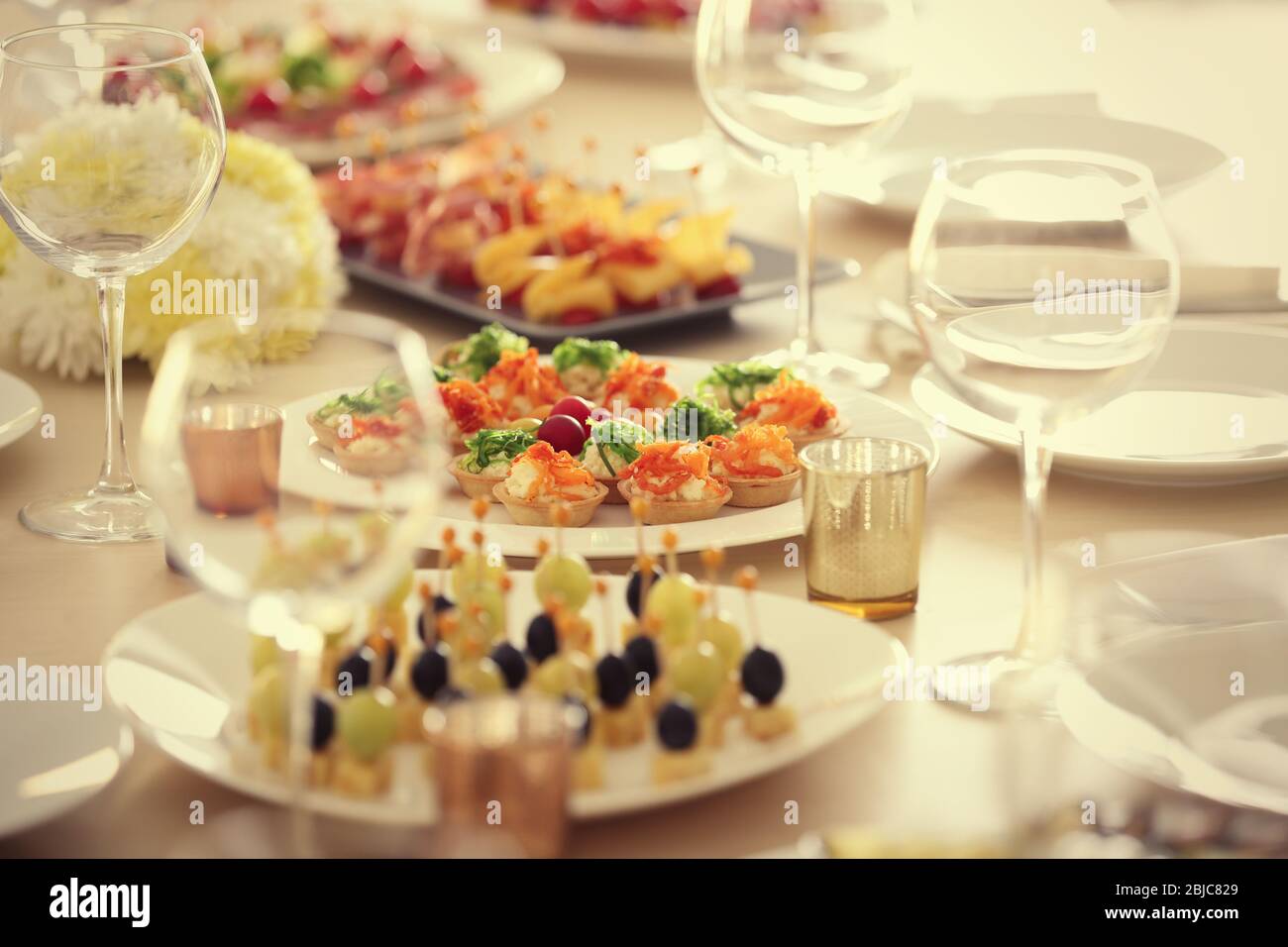 Plate with tasty tartlets on table served for holiday buffet, close up ...