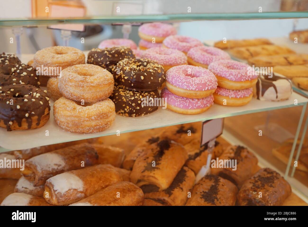 Delicious donuts on store shelves closeup Stock Photo - Alamy