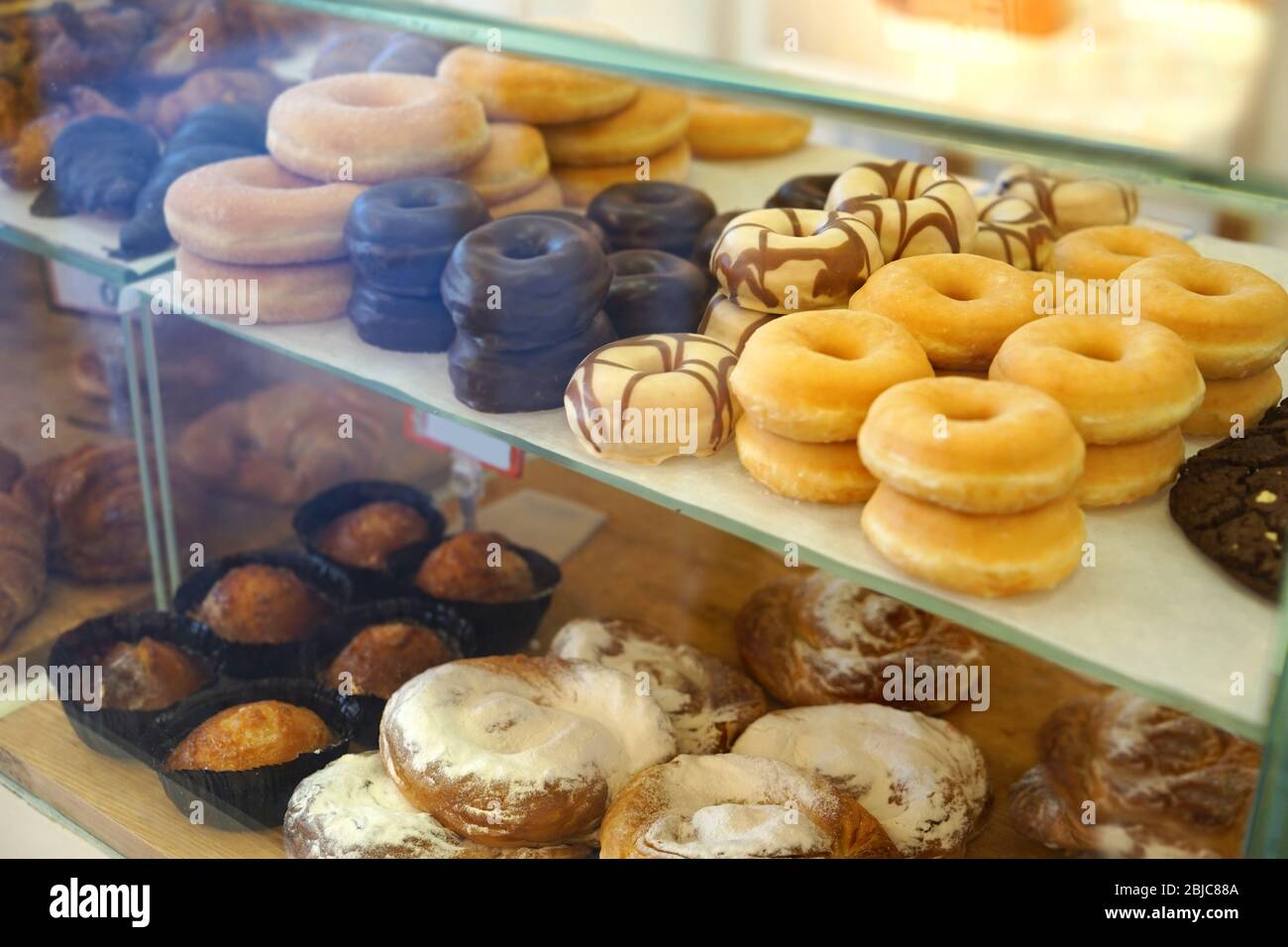 Delicious donuts on store shelves closeup Stock Photo - Alamy