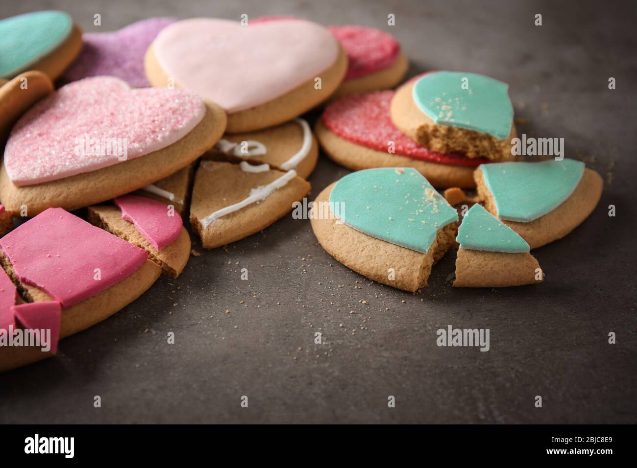 Tasty colourful heart shaped cookies on grey background Stock Photo - Alamy