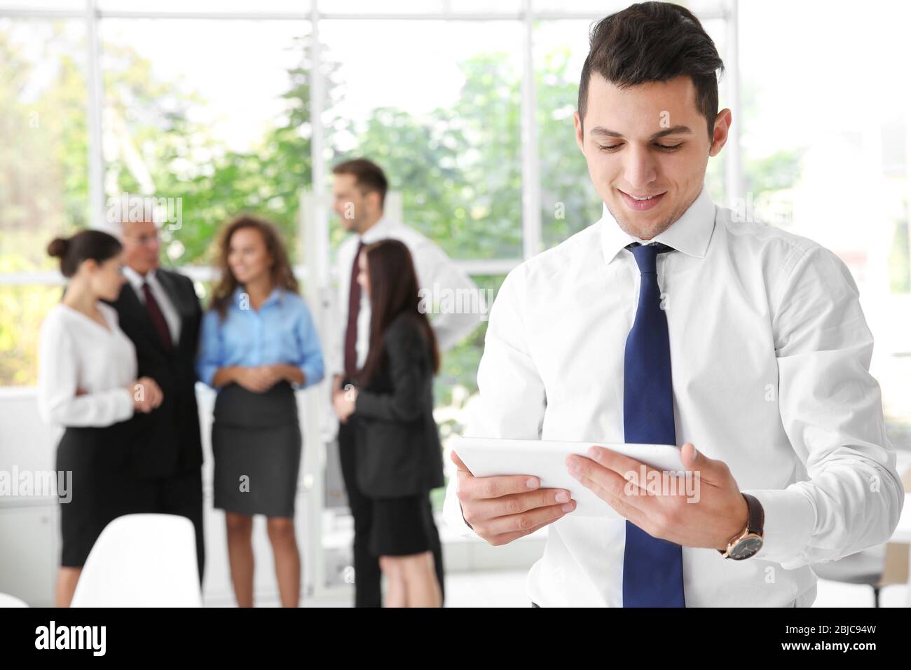 Business training concept. Portrait of young man standing in office ...