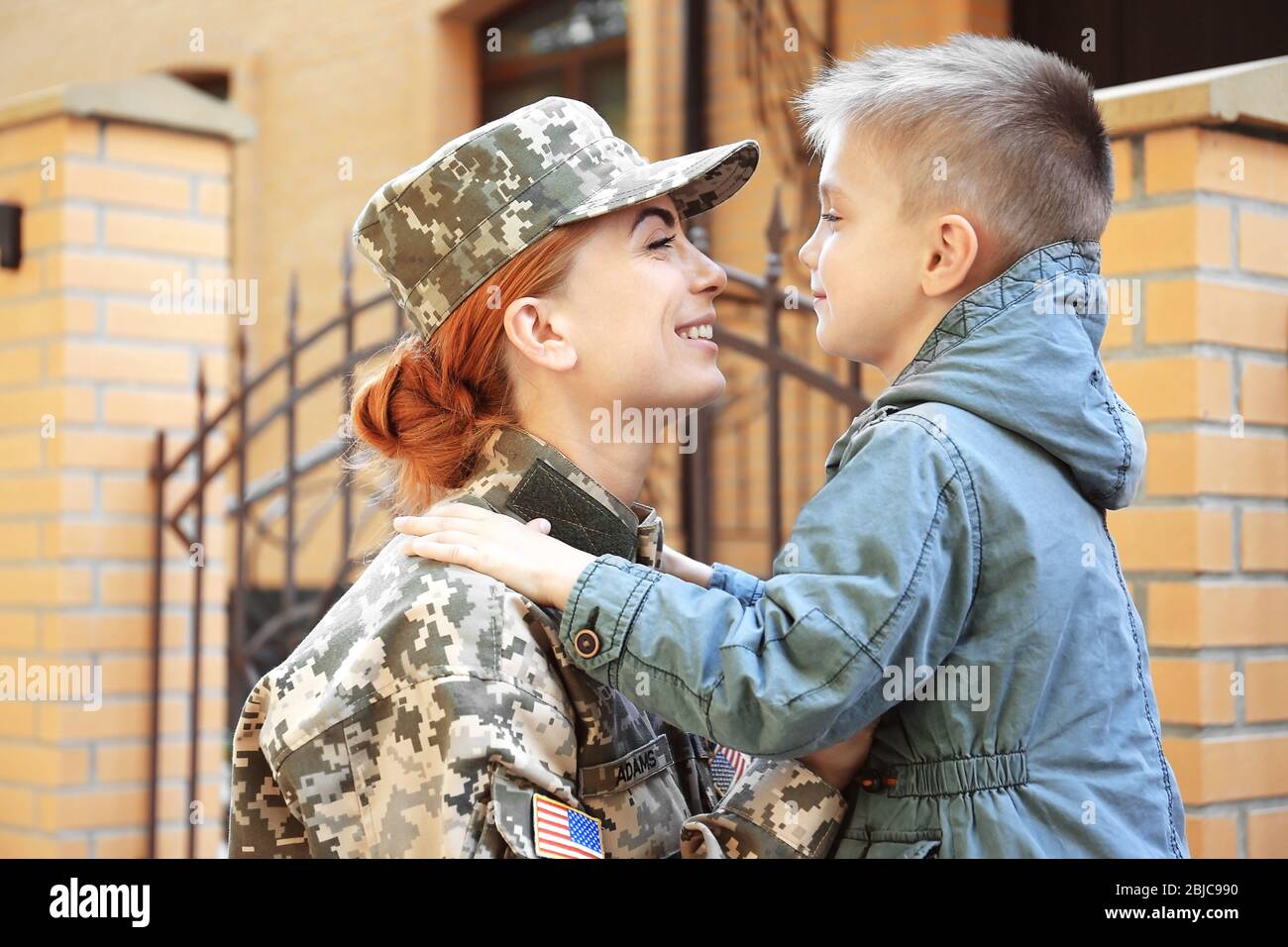 Mother soldier and her son embracing at street Stock Photo - Alamy