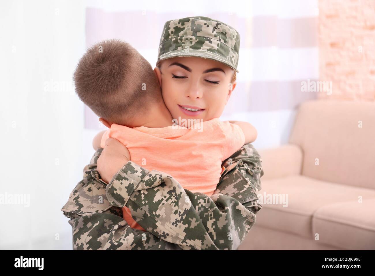 Mother soldier and little kid in the room Stock Photo - Alamy