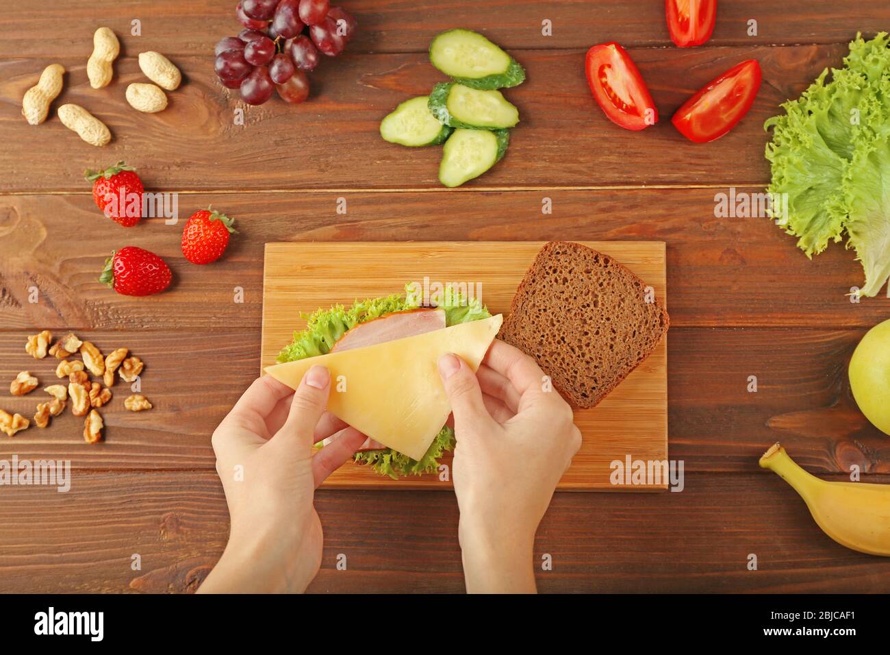 Hands making sandwich on board hi-res stock photography and images - Alamy