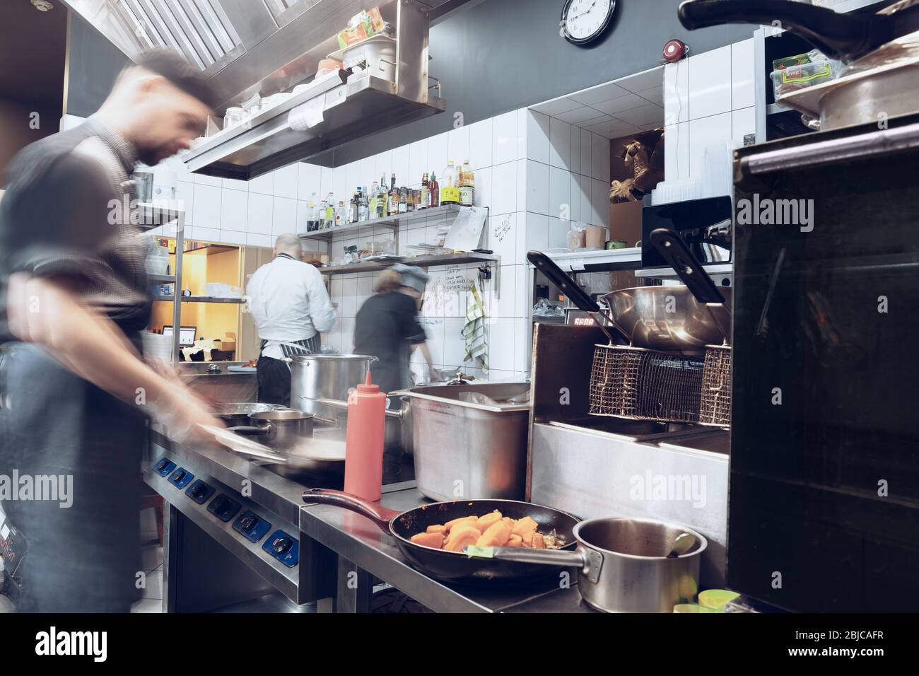Behind the scenes of brands. The chef cooking in a professional kitchen ...