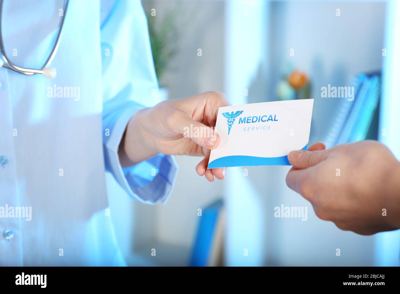 Medical service concept. Female doctor giving visiting card, closeup ...