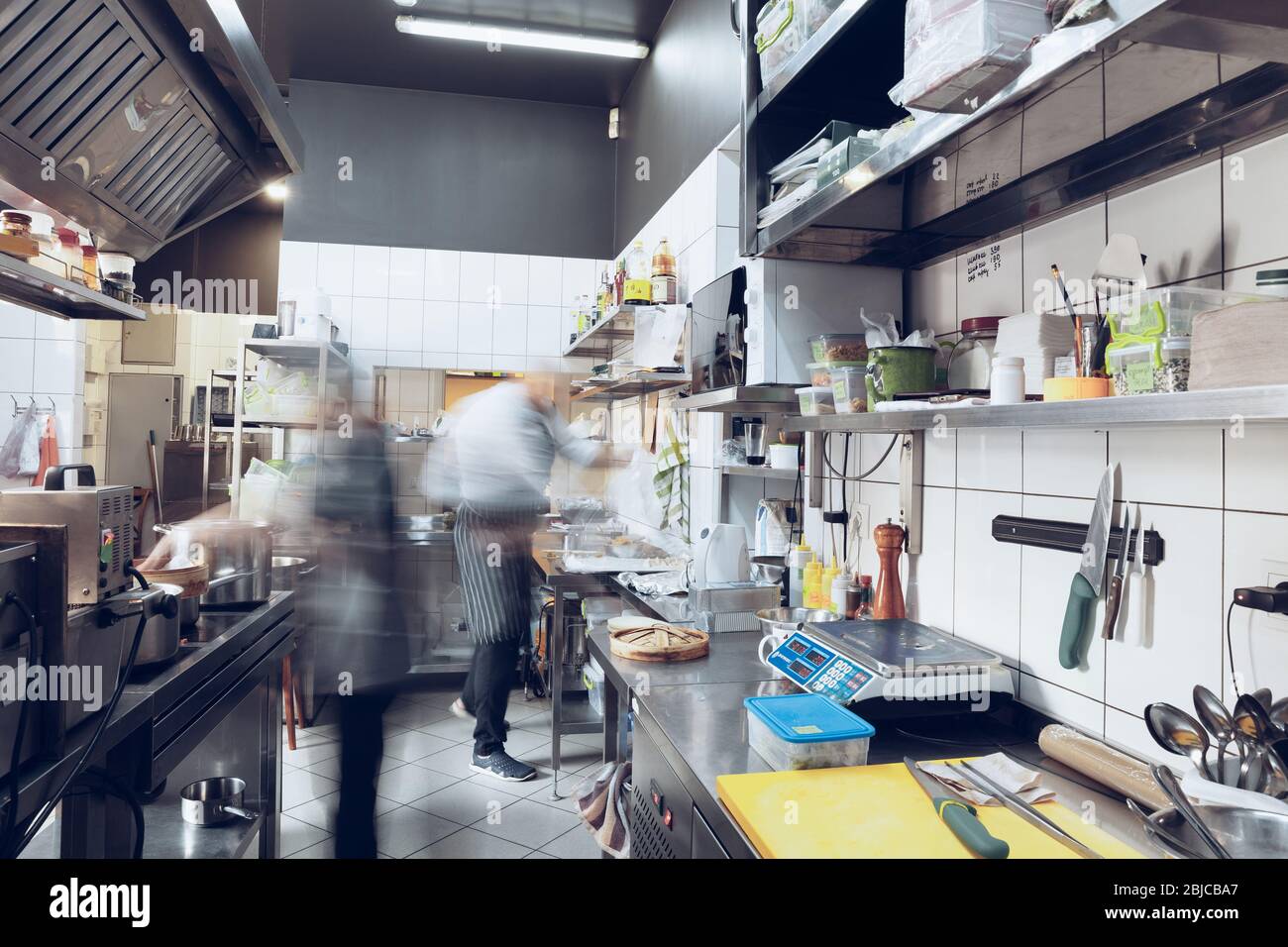 Behind the scenes of brands. The chef cooking in a professional kitchen ...