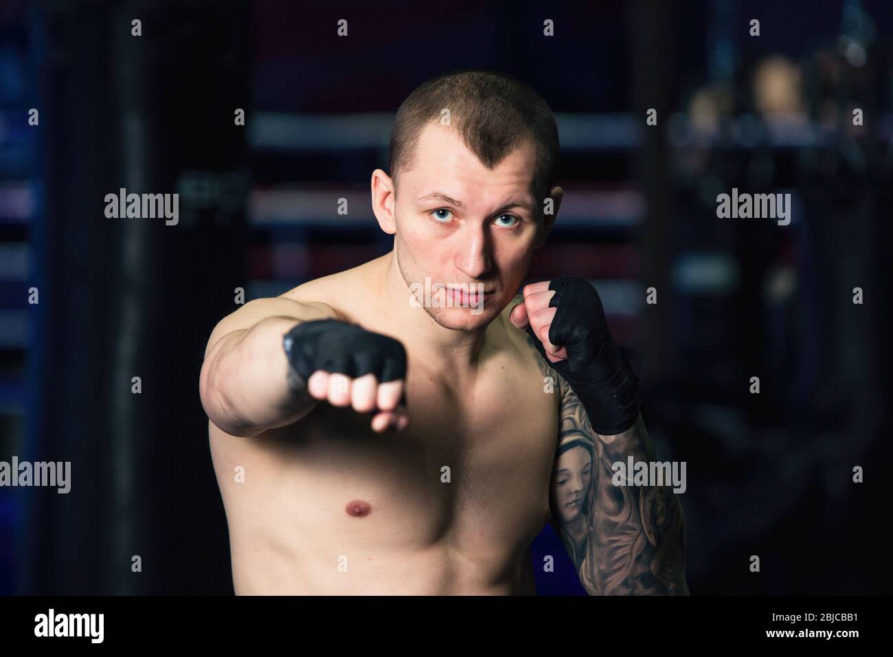 Sports: man kickboxer is practicing kick in a boxing gym Stock Photo ...