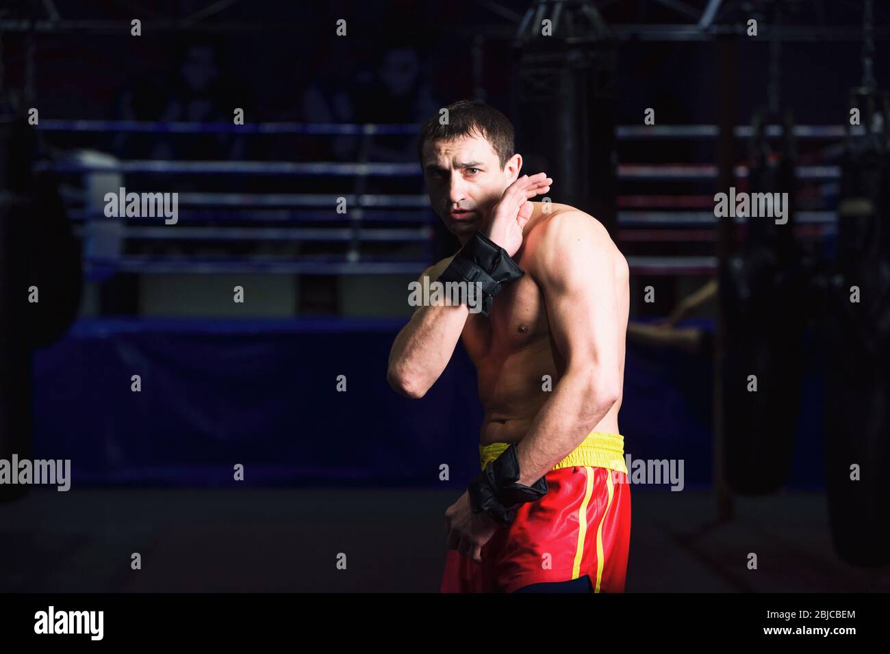 Sports: man kickboxer is practicing kick in a boxing gym Stock Photo ...
