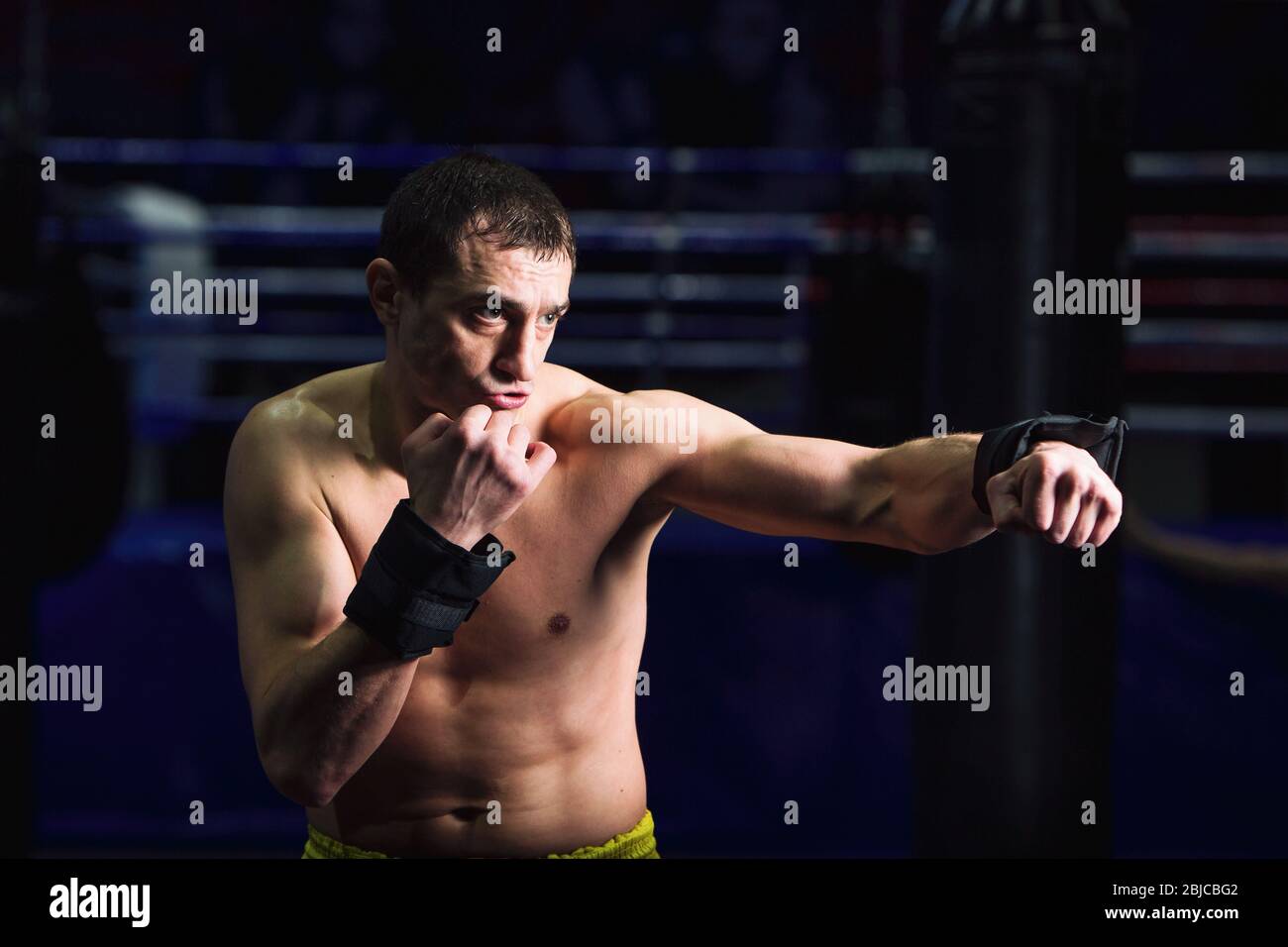 Sports: man kickboxer is practicing kick in a boxing gym Stock Photo ...