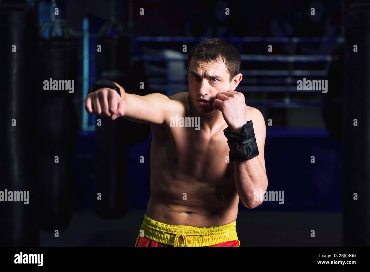 Sports: man kickboxer is practicing kick in a boxing gym Stock Photo ...