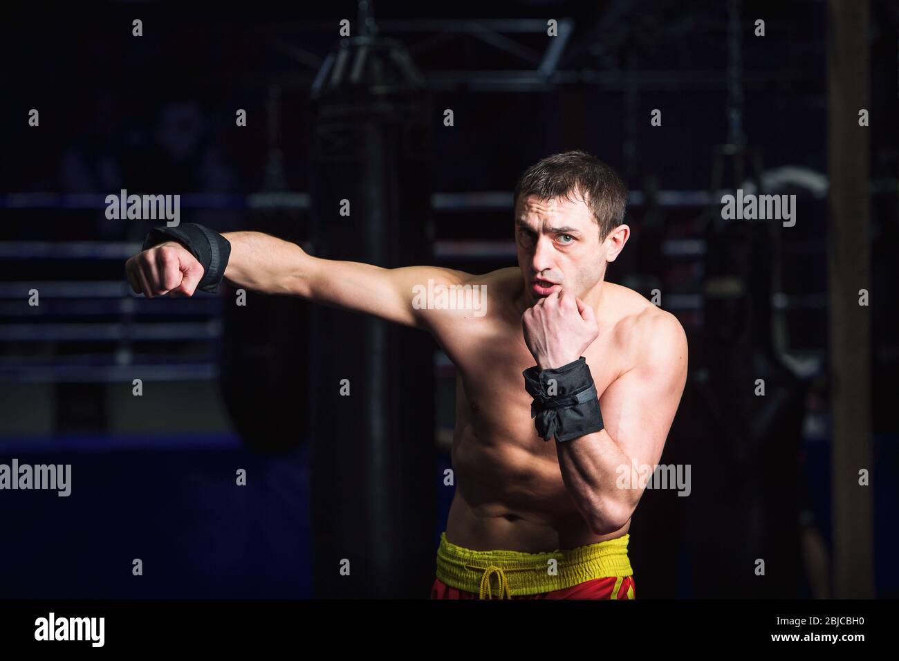 Sports: man kickboxer is practicing kick in a boxing gym Stock Photo ...