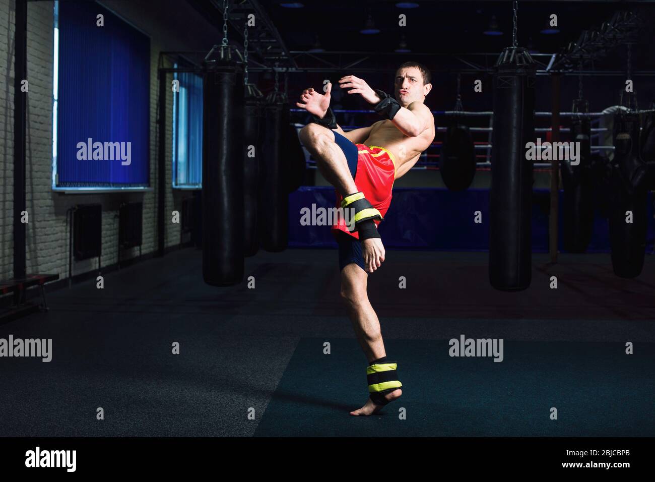 Sports: man kickboxer is practicing kick in a boxing gym Stock Photo ...