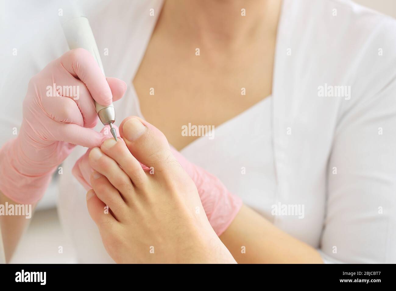 Patient on medical pedicure procedure, visiting podiatrist.Professional ...