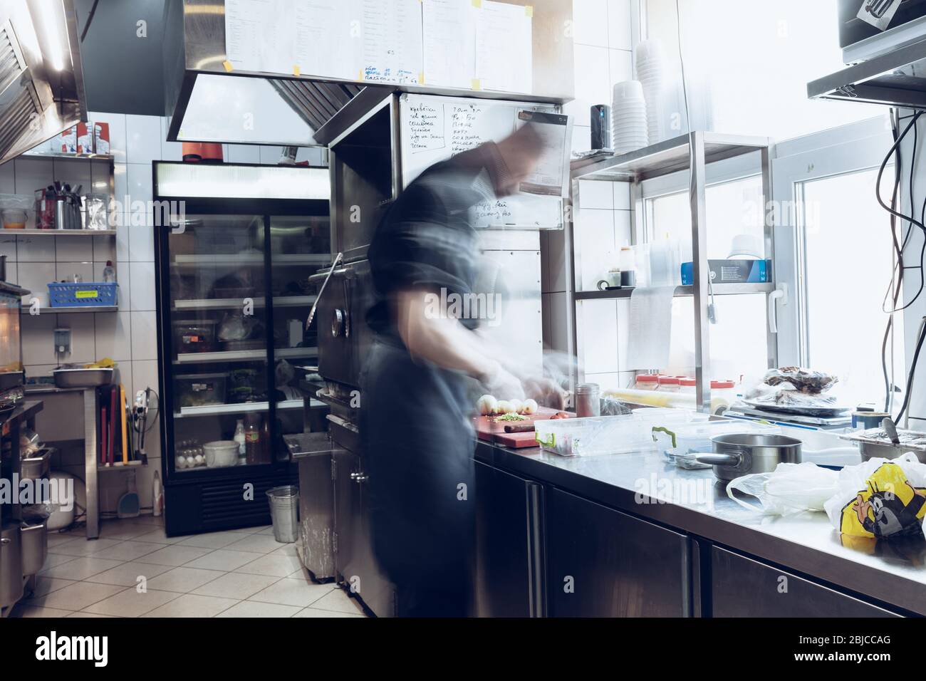 Behind the scenes of brands. The chef cooking in a professional kitchen ...