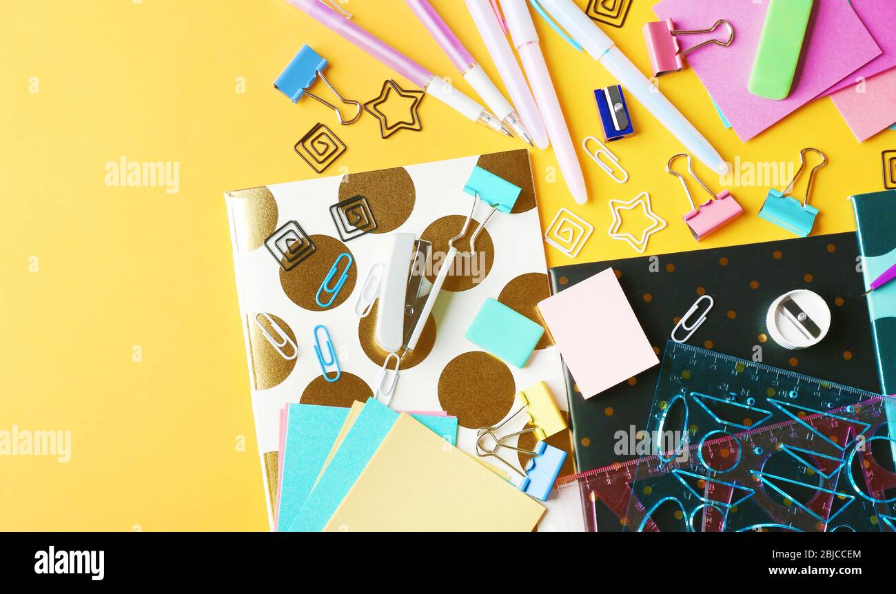 Colorful stationery on yellow background Stock Photo - Alamy