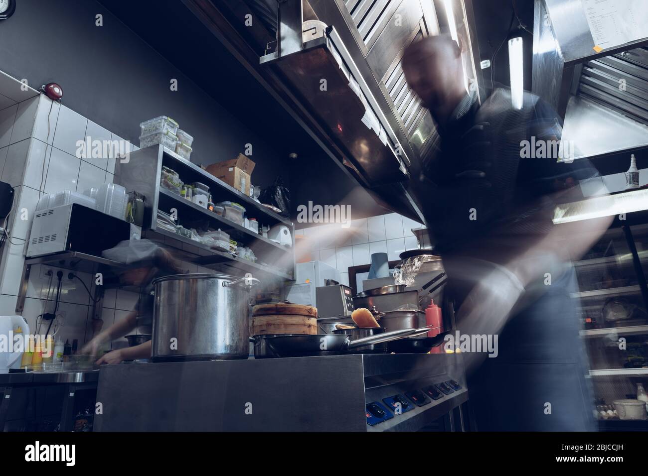 Behind the scenes of brands. The chef cooking in a professional kitchen ...