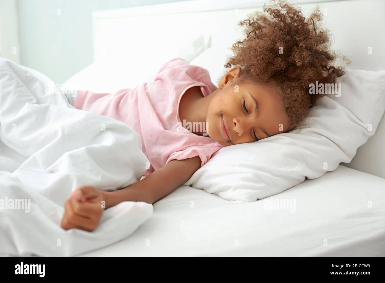 Little African American girl resting in bed Stock Photo - Alamy