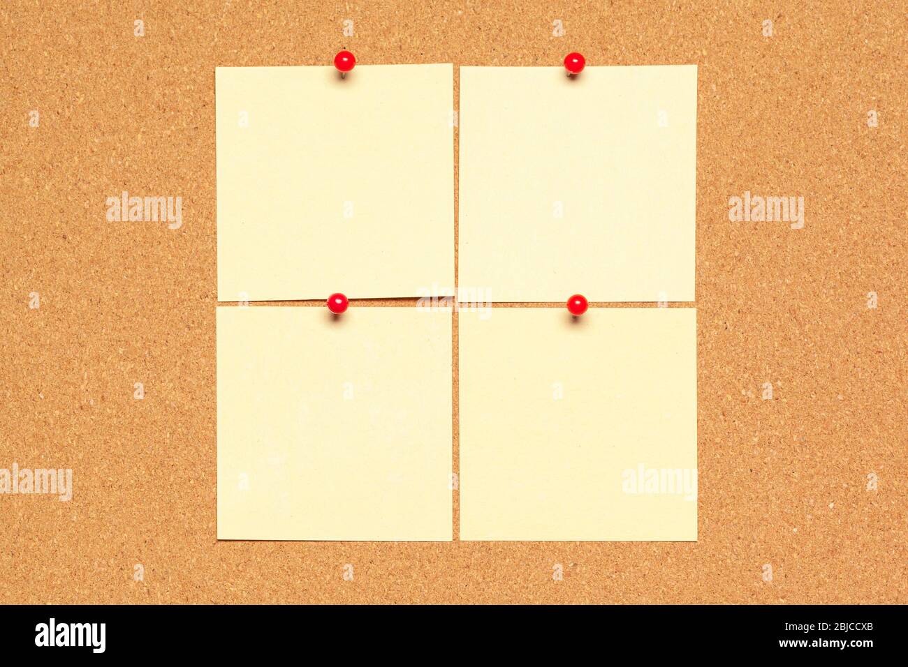 Sticky note pinned on cork board with thumbtacks Stock Photo - Alamy