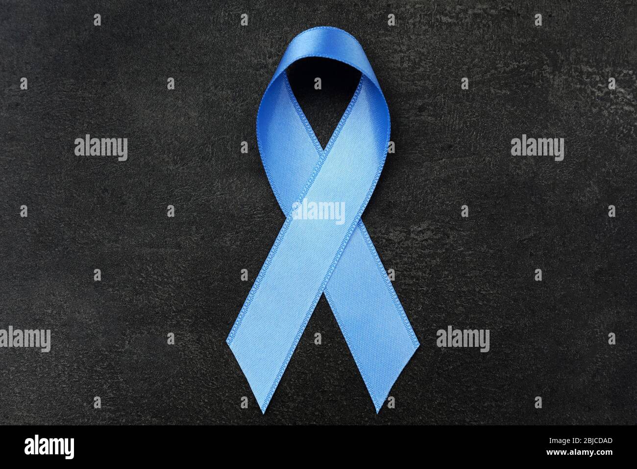 Light blue ribbon on dark background. Prostate cancer concept Stock ...