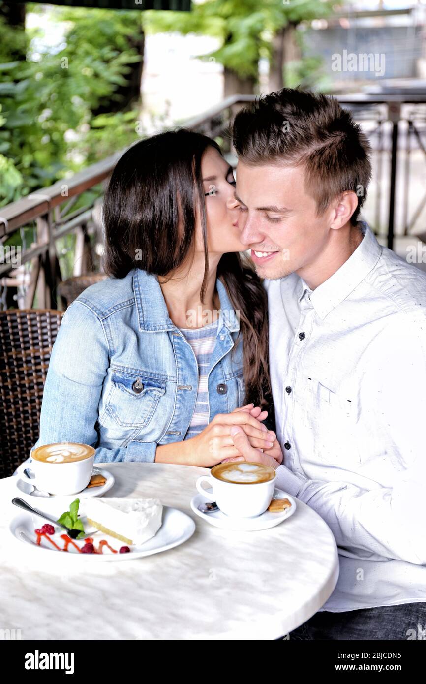 Romantic couple kissing having coffee hi-res stock photography and ...