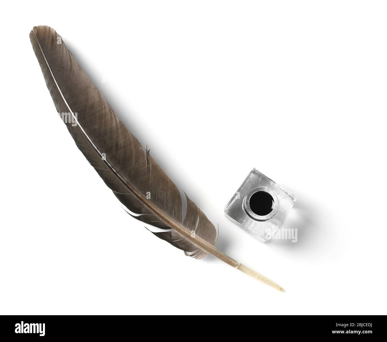 Feather pen and inkwell isolated on white Stock Photo - Alamy