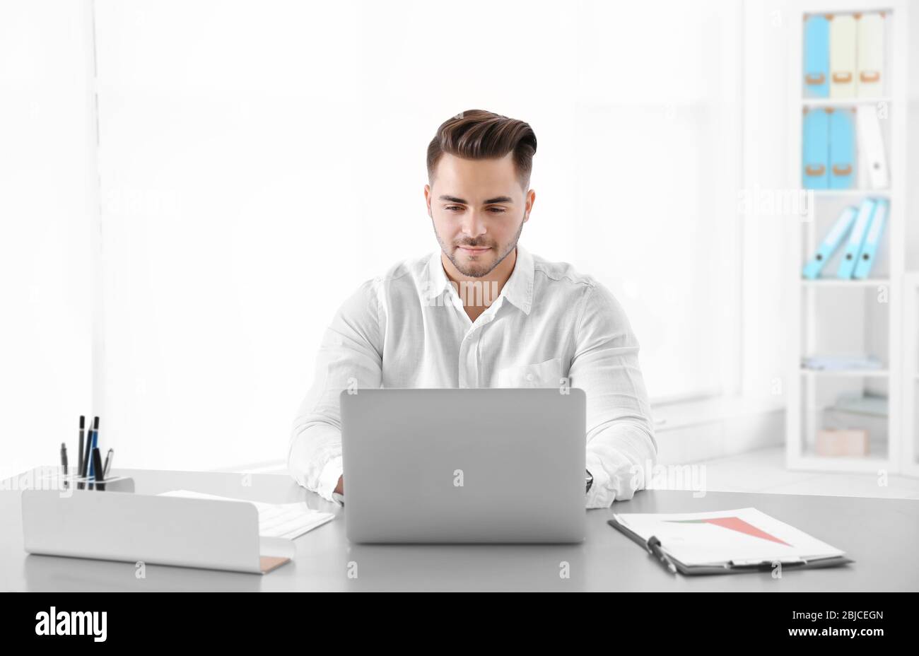 Handsome man working in office Stock Photo - Alamy