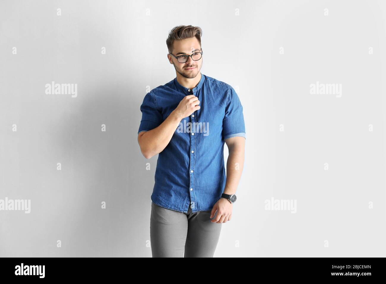 Handsome man on wall background Stock Photo - Alamy