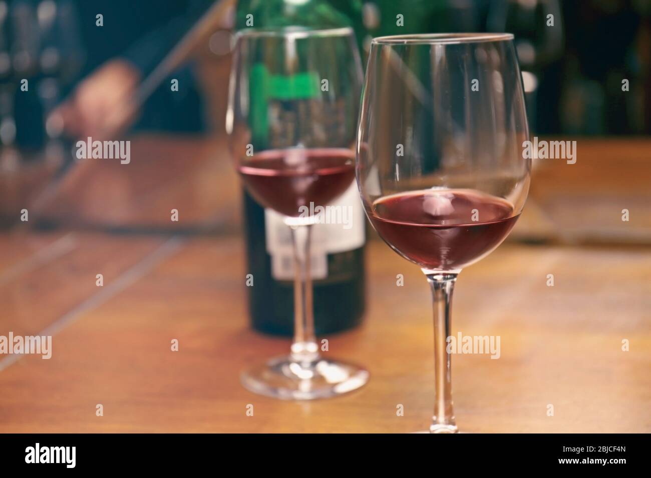 Glasses of red wine on bar counter Stock Photo - Alamy