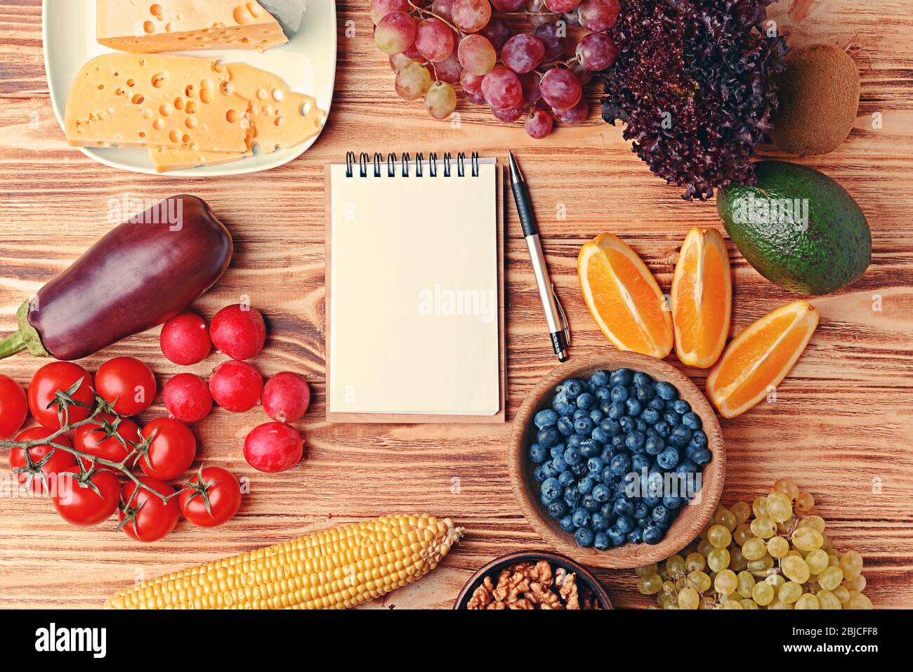 Notebook with pen and healthy food on wooden background Stock Photo - Alamy