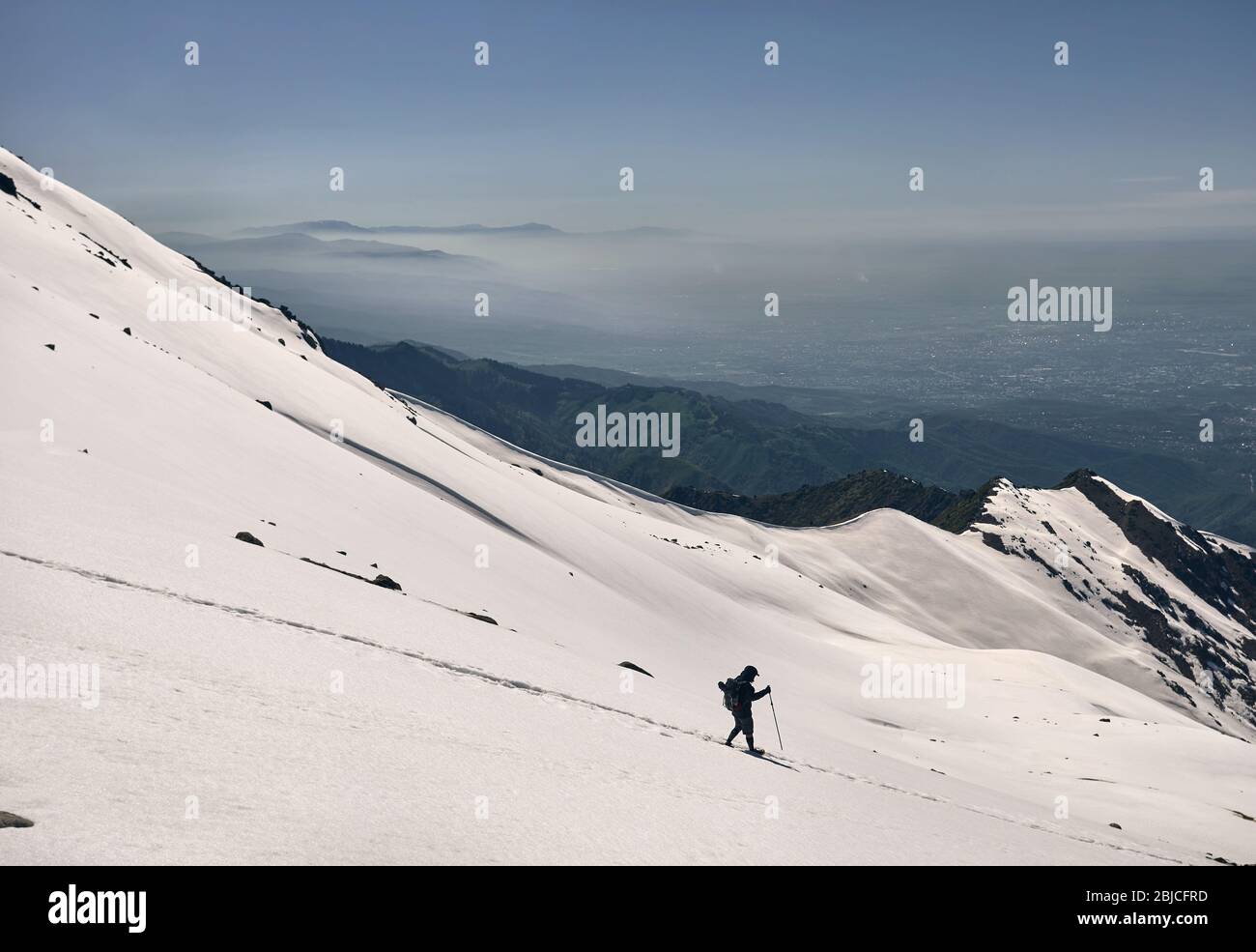 Tourist in the snow path in the beautiful mountains at winter with city ...