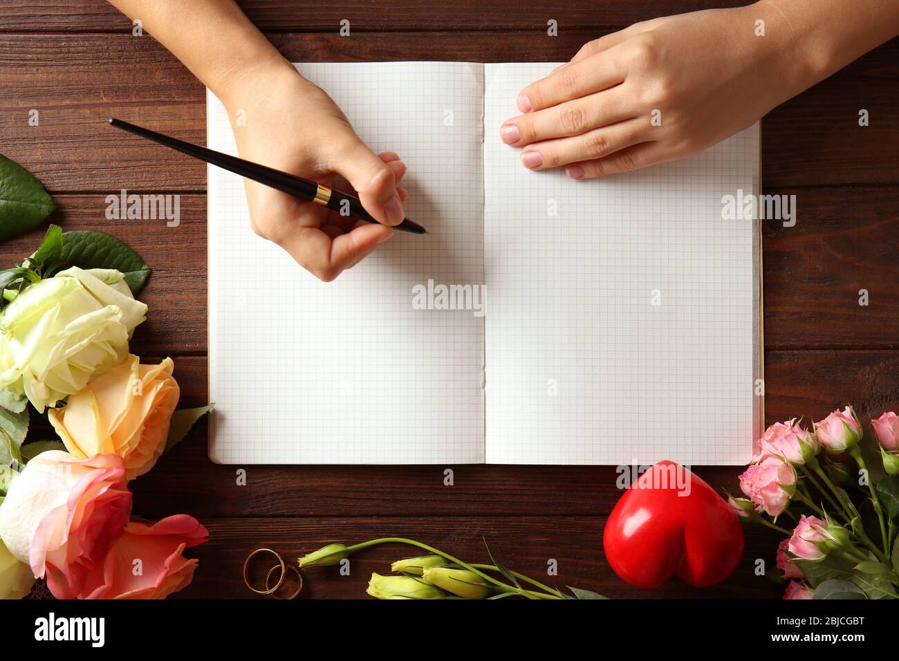Female hands writing wedding to do list on table Stock Photo - Alamy
