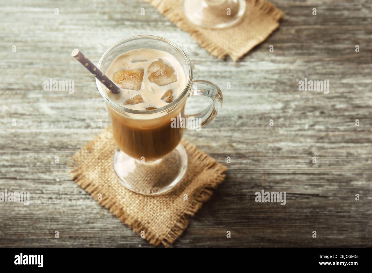 Glass of cold coffee on table Stock Photo - Alamy