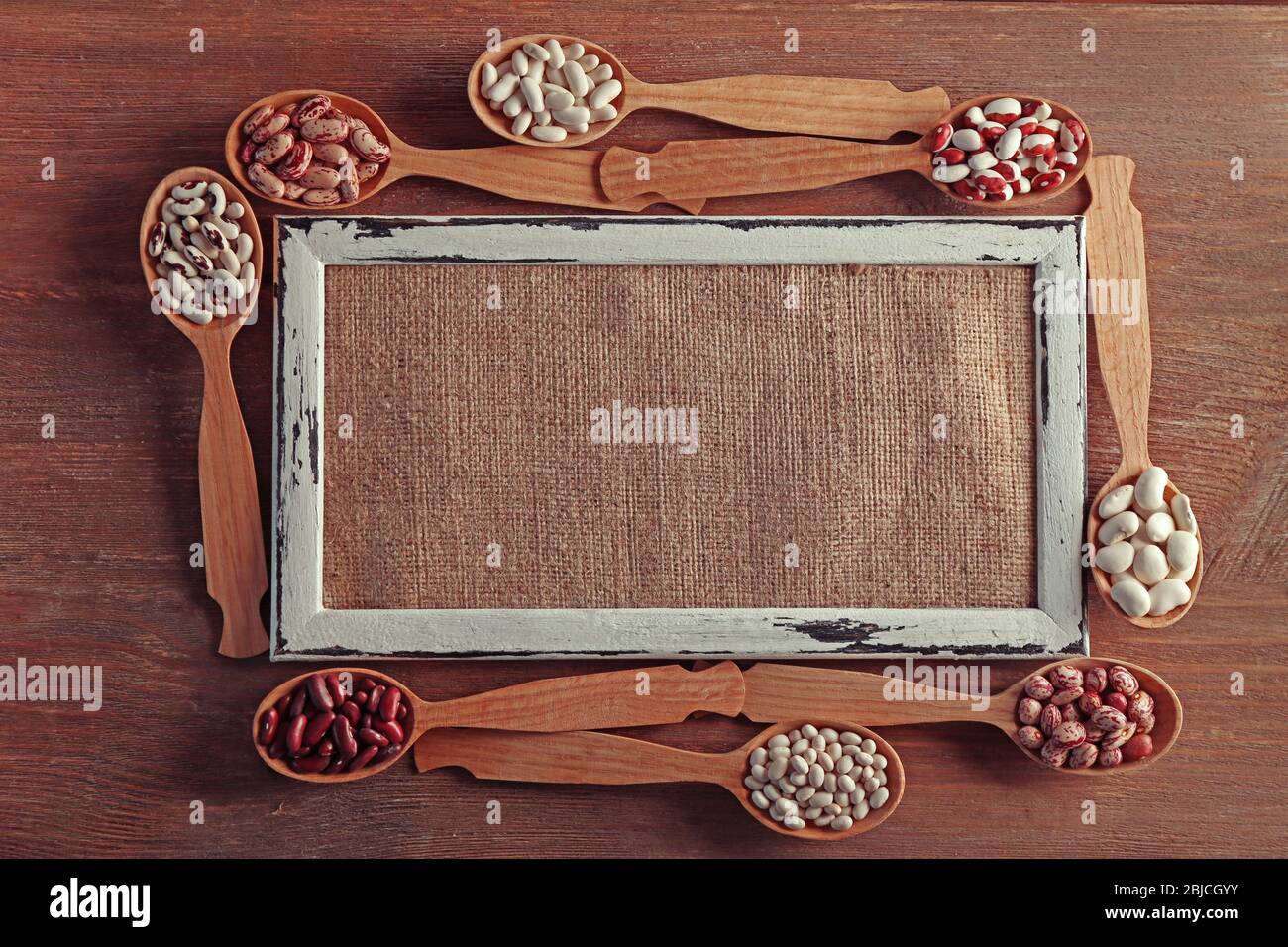 Frame of spoons with different beans and bagging with space for text ...