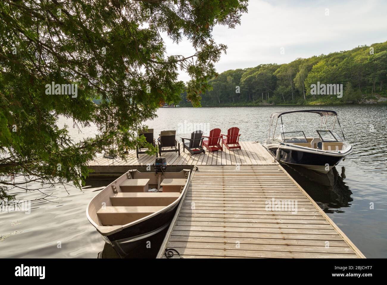 Boat dock and chairs, summer at the cottage Stock Photo - Alamy