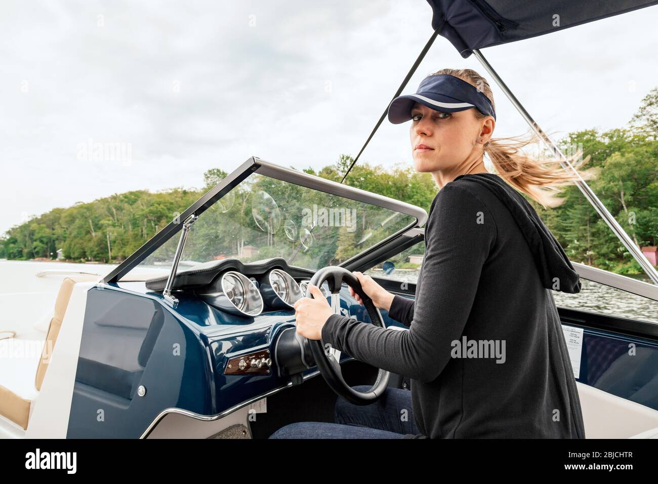 Young woman steering boat hi-res stock photography and images - Alamy