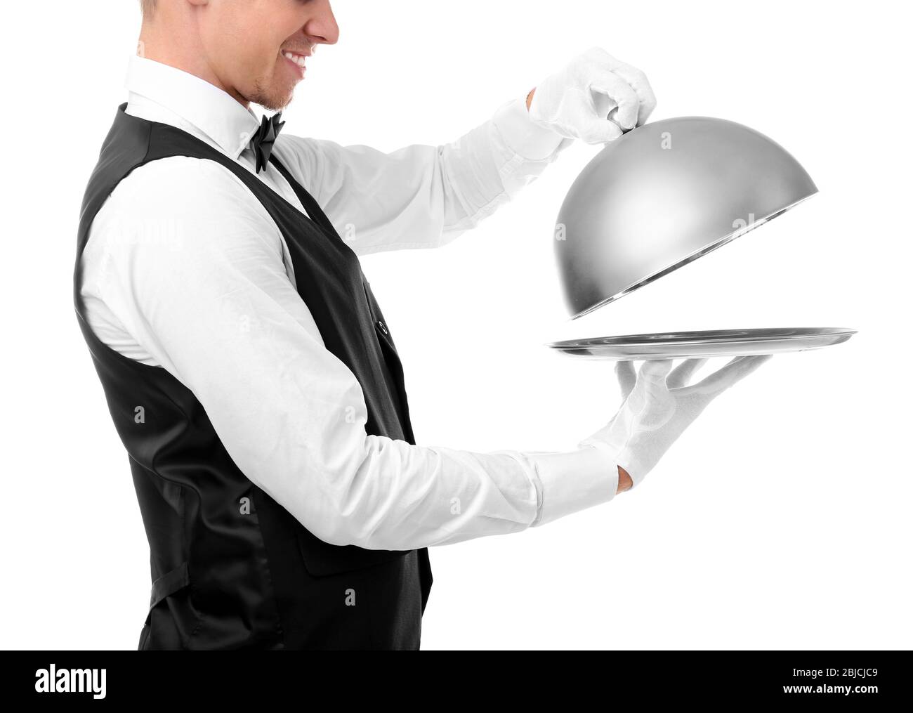Handsome young waiter with cloche and tray on white background Stock ...