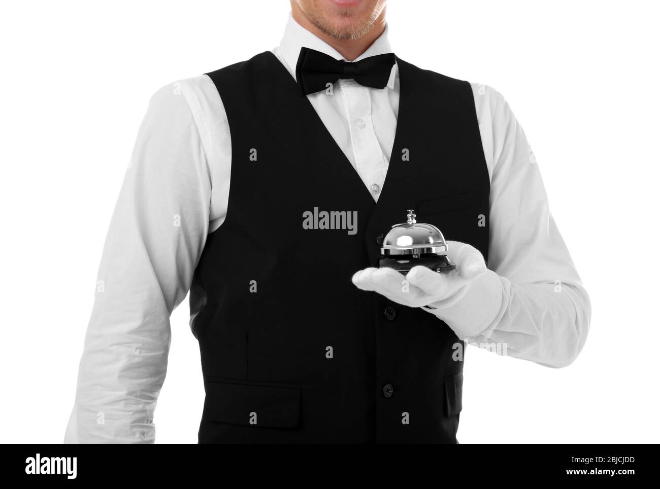 Young waiter with service bell on white background Stock Photo - Alamy