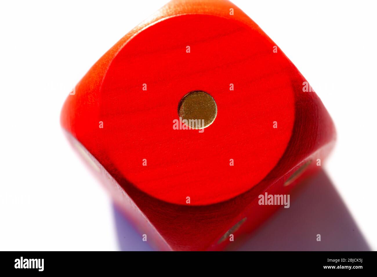 Simple red game dice showing one. Number 1 on a big wooden playing dice ...