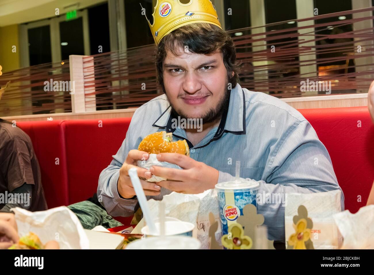 Johannesburg, South Africa - June 27, 2014: Male customer eating at a ...