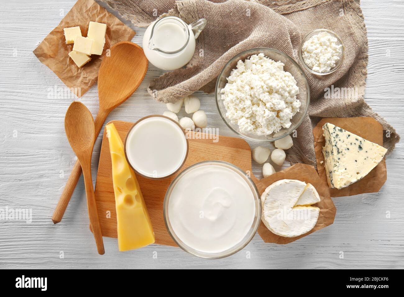 Different types of dairy products on wooden background Stock Photo - Alamy